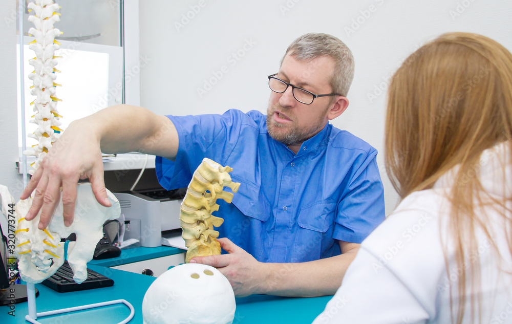 The doctor osteopath and chiropractor in the hospital explains to the ...