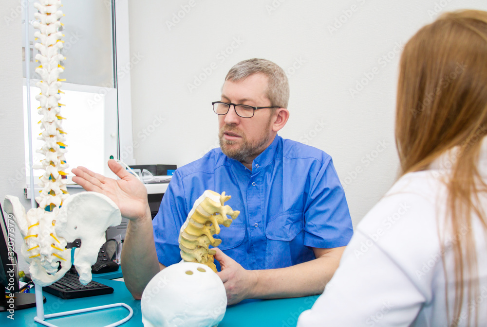 The doctor osteopath and chiropractor in the hospital explains to the ...