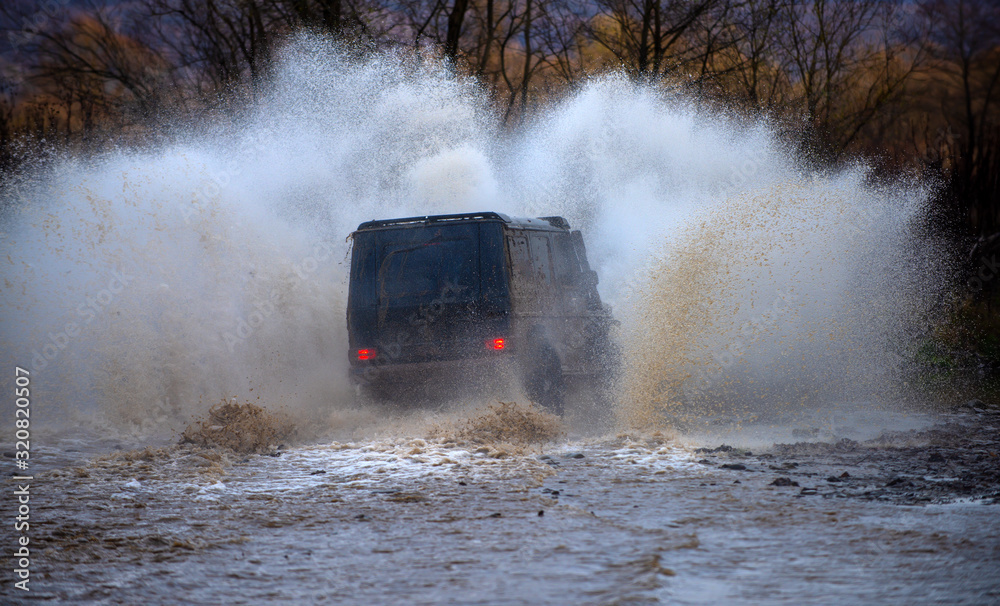Off road. Four by four off road car crossing the lake with splashing ...