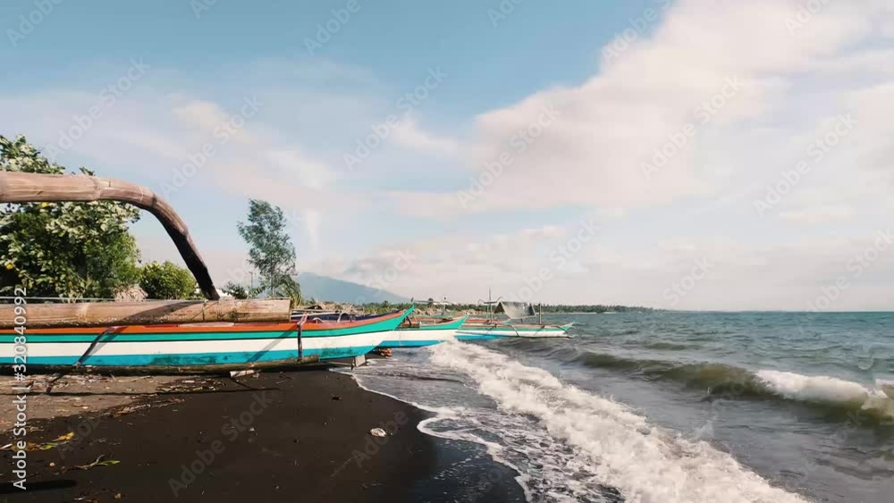 Traditional fishing boats by the Palale Beach in Albay, Philippines ...