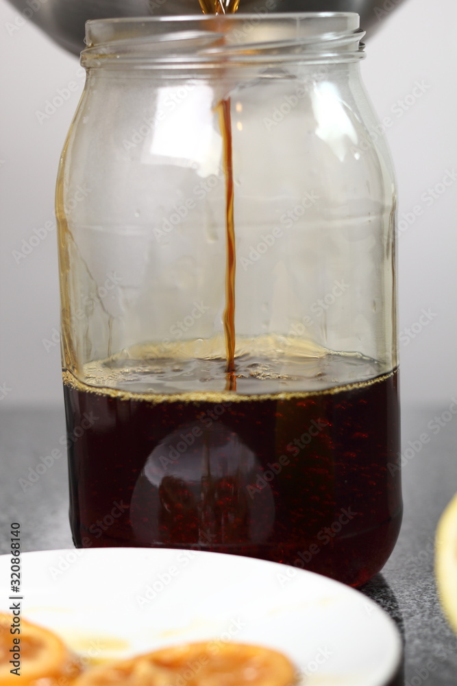 Pouring syrup into sterilised jars. Making Golden Syrup Series. Stock ...