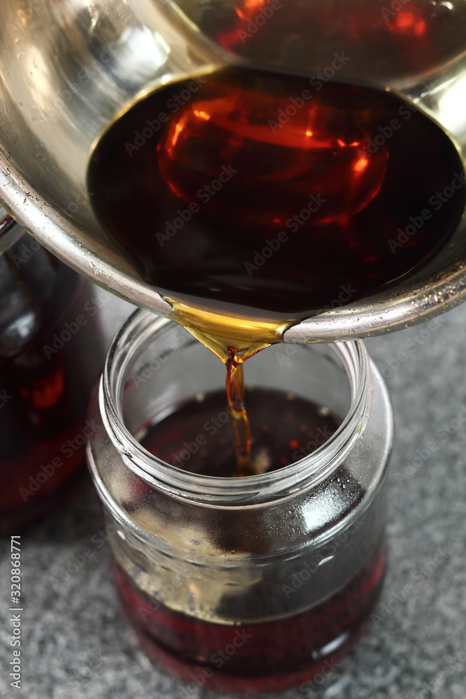 Pouring syrup into sterilised jars. Making Golden Syrup Series. Stock ...