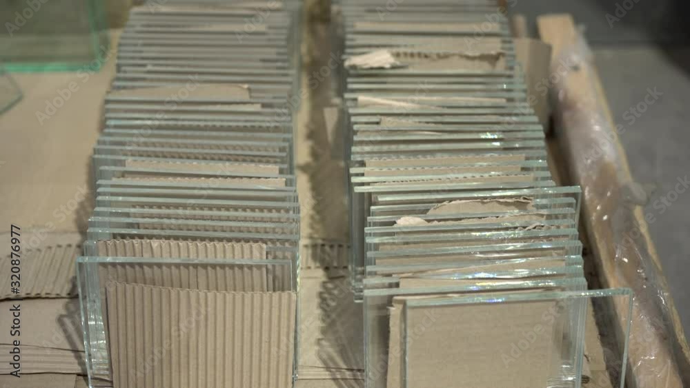 Multiple glass panels stacked in a row with a spacer made by cardboard ...