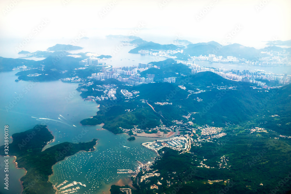 Aerial view of Hong Kong islands with harbour from a flying airplane ...