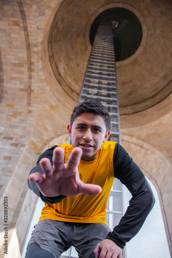 From below a man reaching the camera with his hand in a huge ...