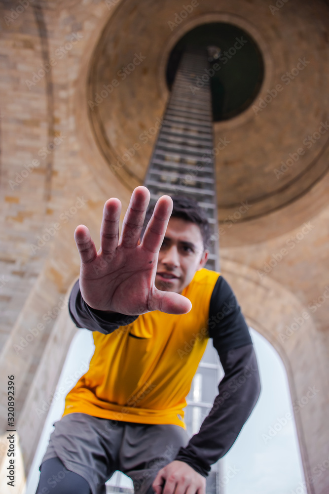 From below a man reaching the camera with his hand in a huge ...