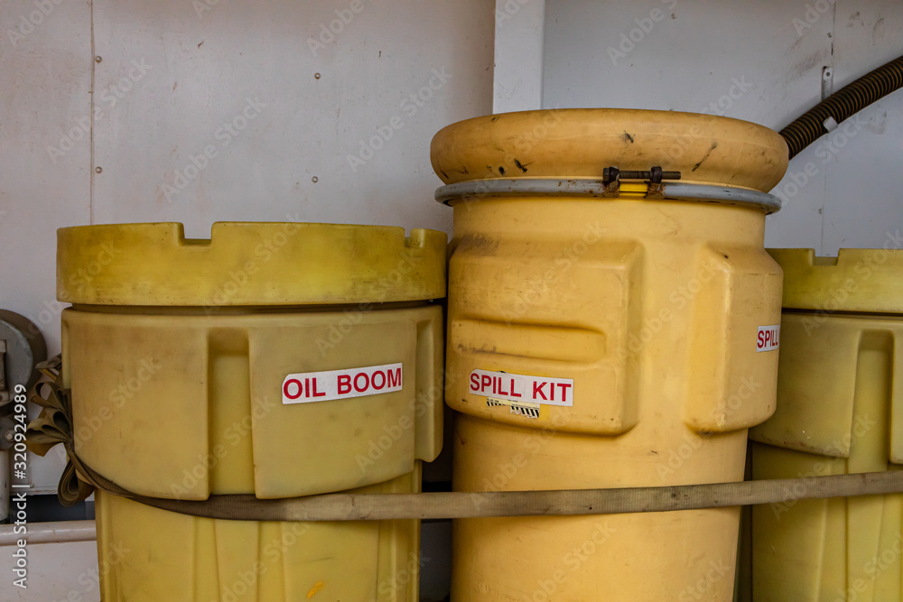 Two bright yellow plastic bins, labeled with oil Boom and Spill kit ...