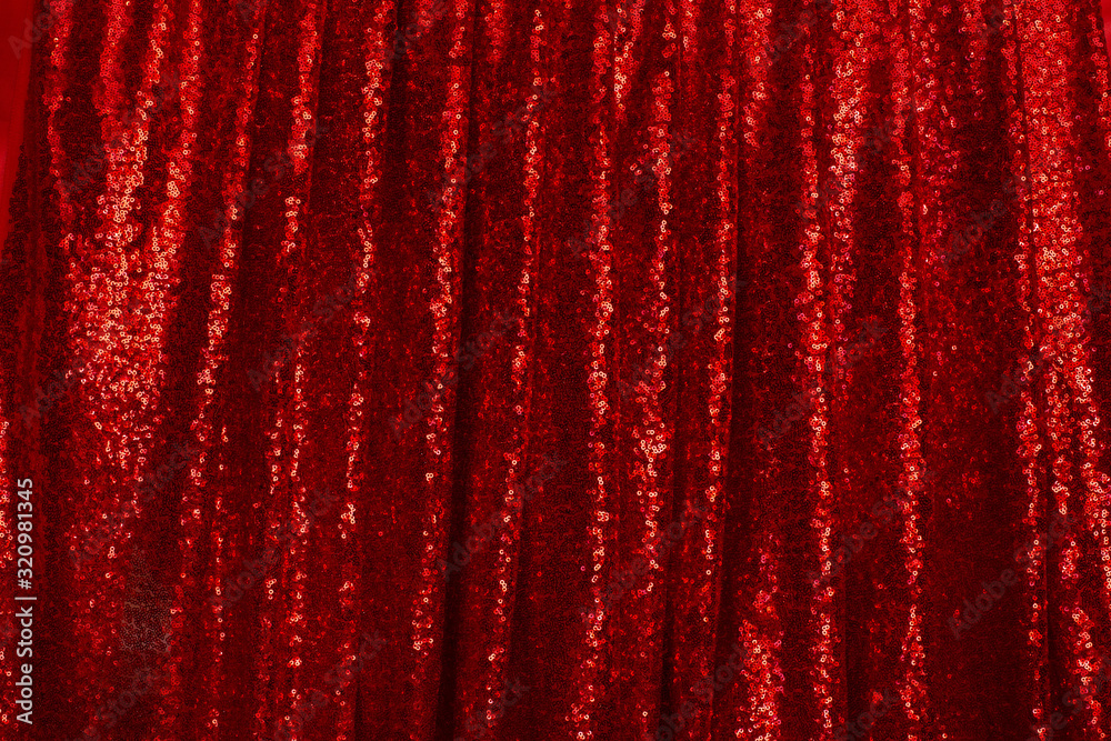 red drapery made of bright shiny fabric with round pleats hanging in ...