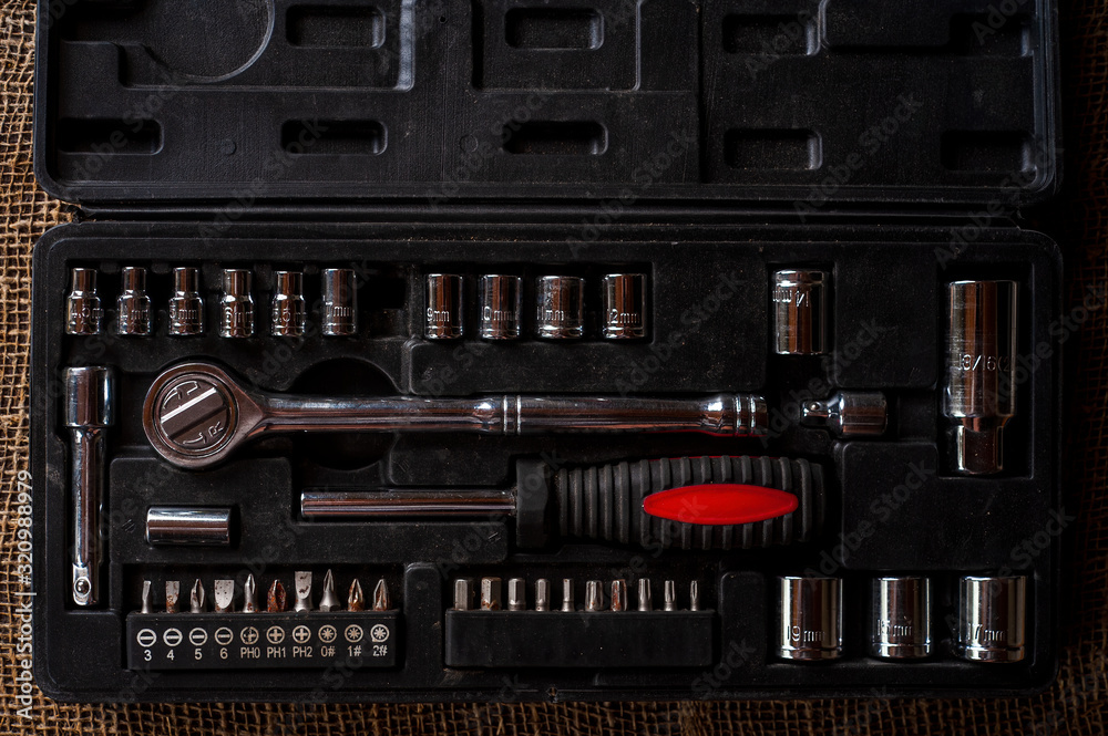 Set of tools with attachments and adapters for twisting nuts and bolts ...