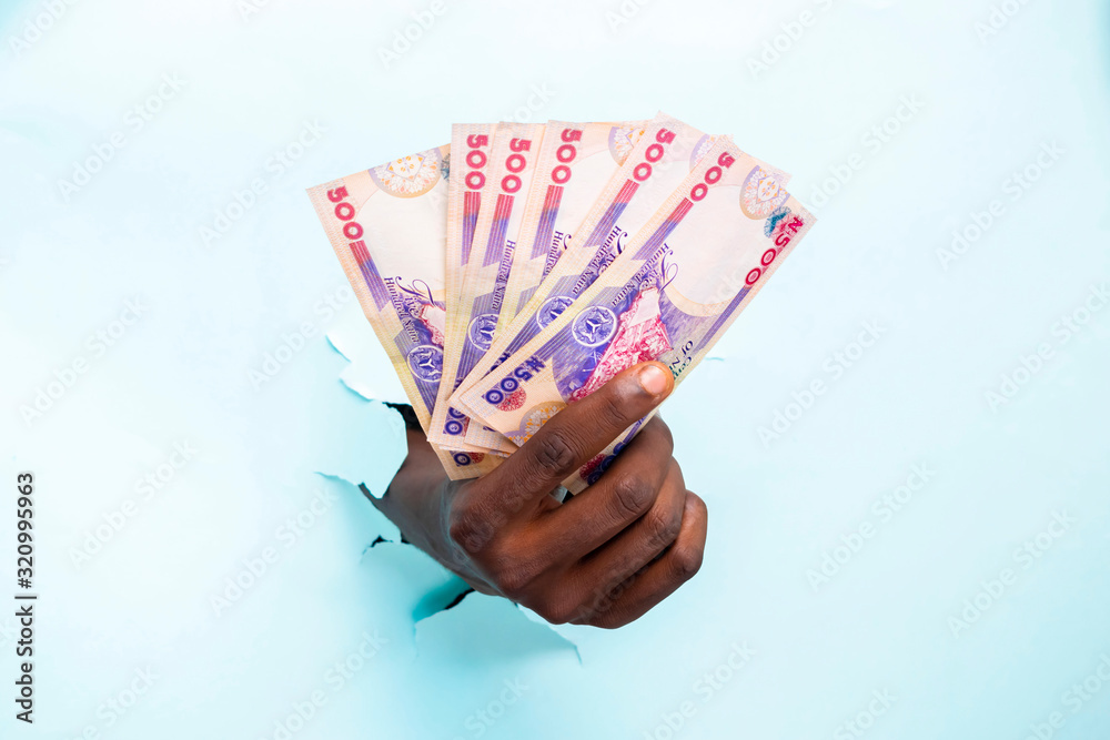 black hand holding some naira notes Stock Photo | Adobe Stock