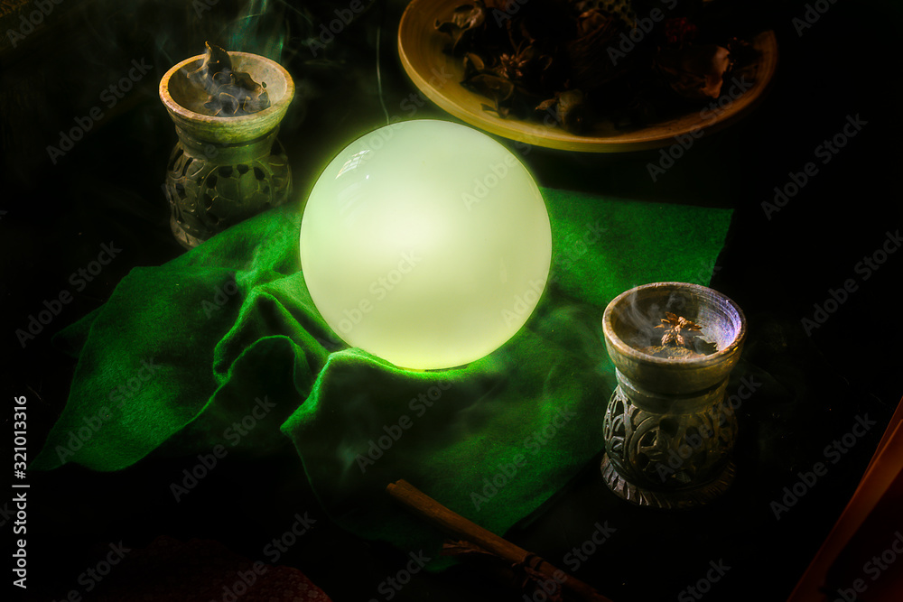 Crystal ball to guess the future, on a divination table. Stock Photo ...