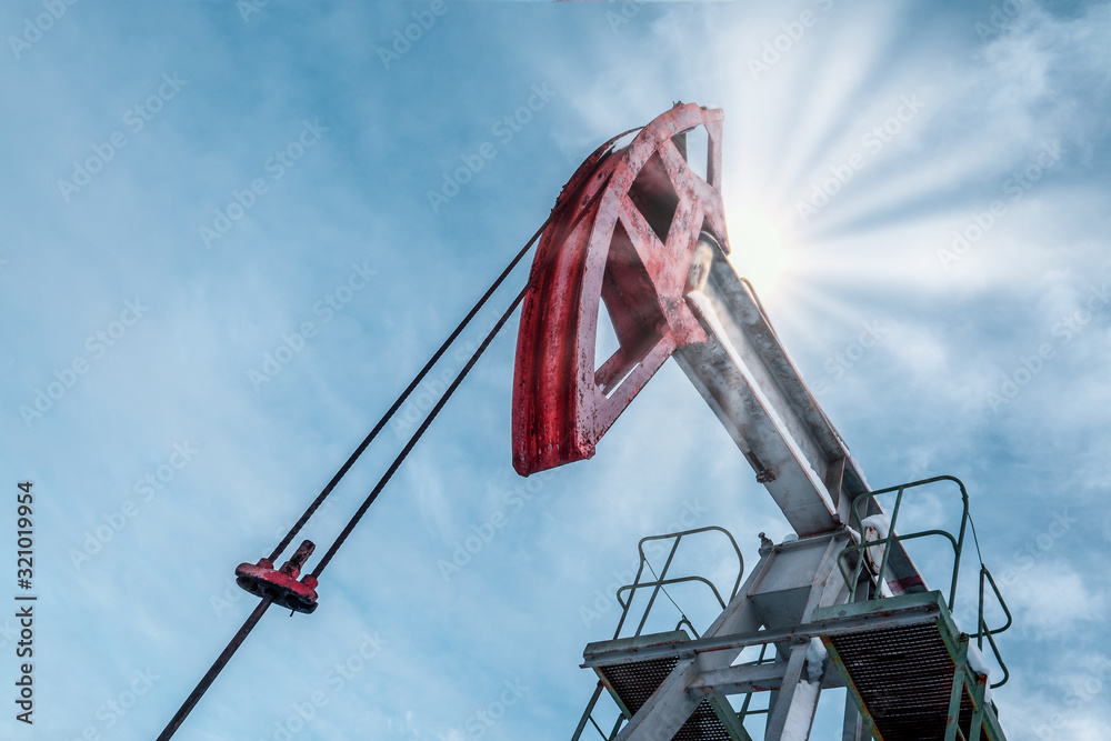 Oil pump jack rocking with pipeline in the background. Rocking machines ...