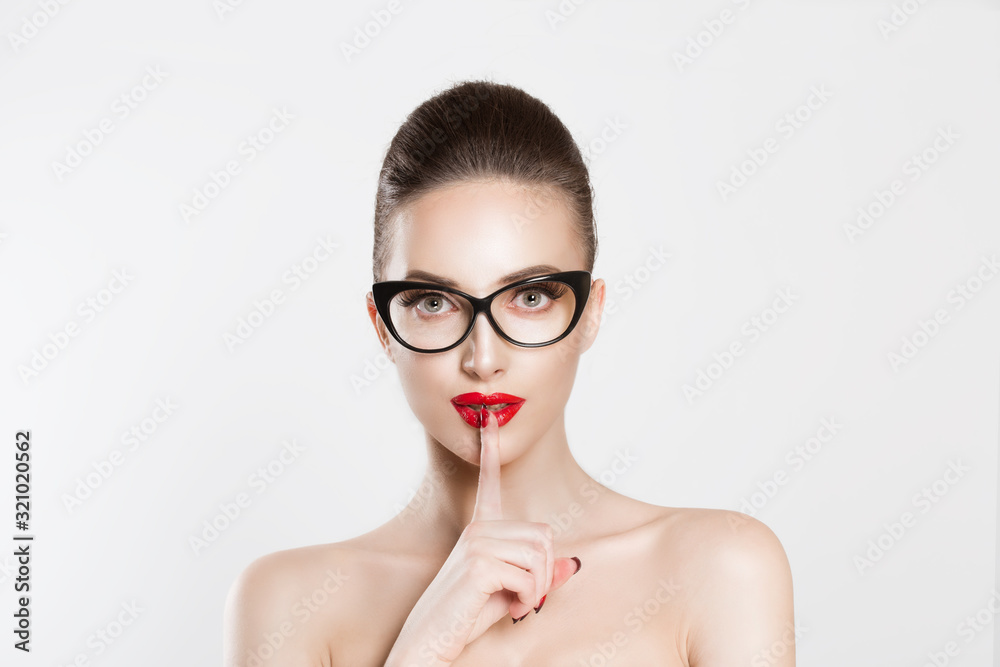 Woman wide eyed asking for silence secrecy with finger on lips hush ...