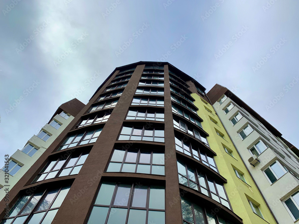 Multi-storey building on a background of blue sky. Tall building with ...