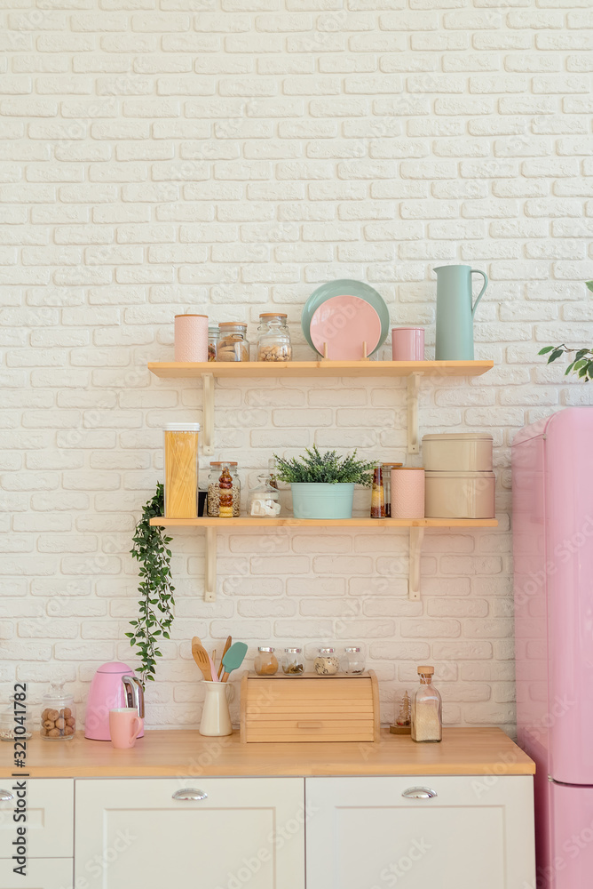 Kitchen shelves, wooden surface and pink fridge on white background ...