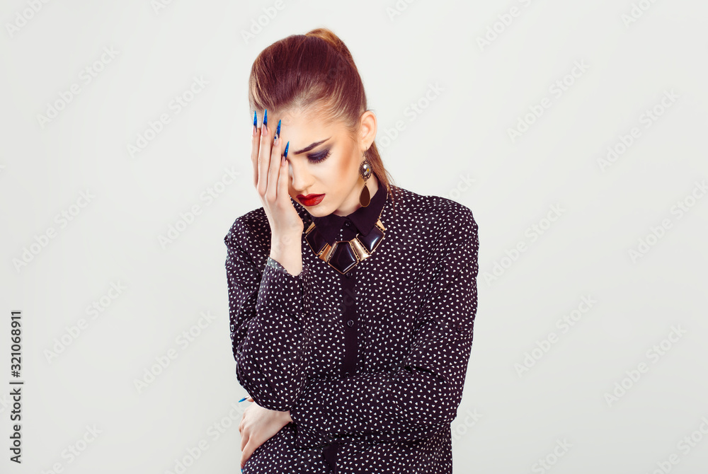 Sadness. Closeup portrait young woman sad, hand on face looking down ...