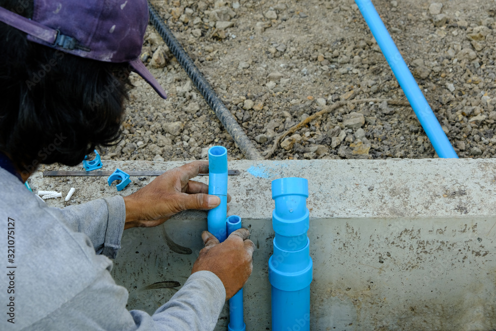 plumber man worker install pvc pipe for infrastructure building house ...