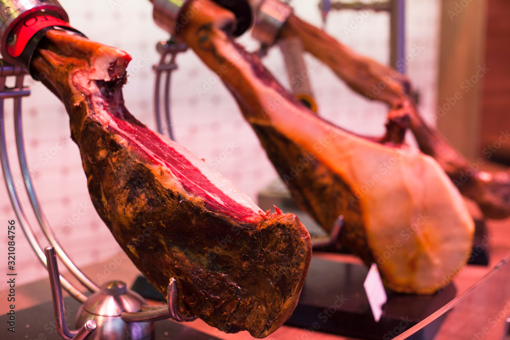 Pig legs in a shop window of a butcher shop. Natural Ham on market ...