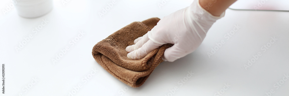 Focus on gloved male hand holding cloth and swiping all dirt and dust ...