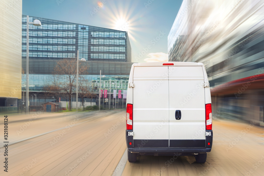 Small cargo delivery van driving in european city central district ...