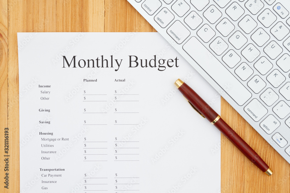 Creating your monthly budget online and a pen with a keyboard Stock ...