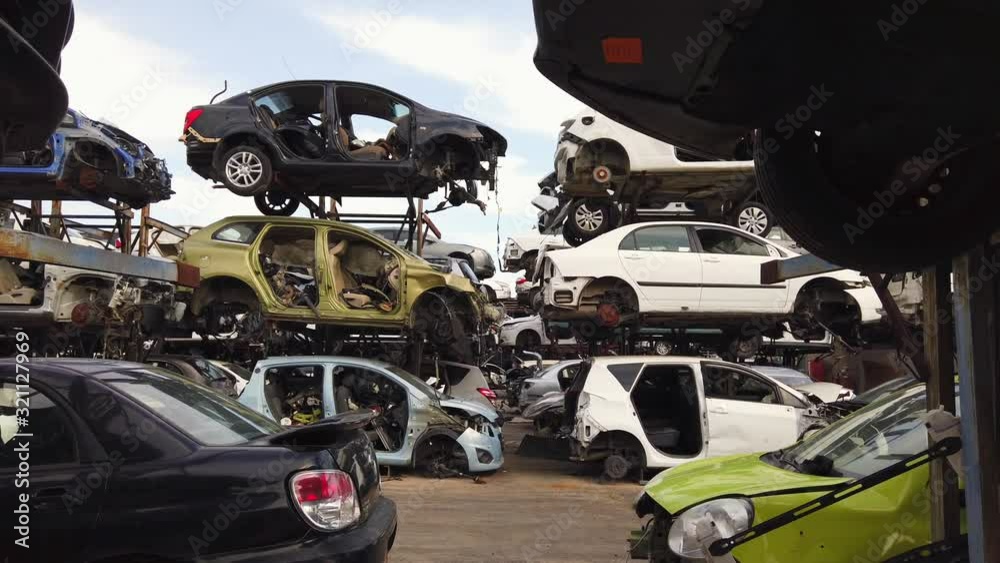 Large Salvage Car parts and Vehicles lot, with rows of stacked totalled ...