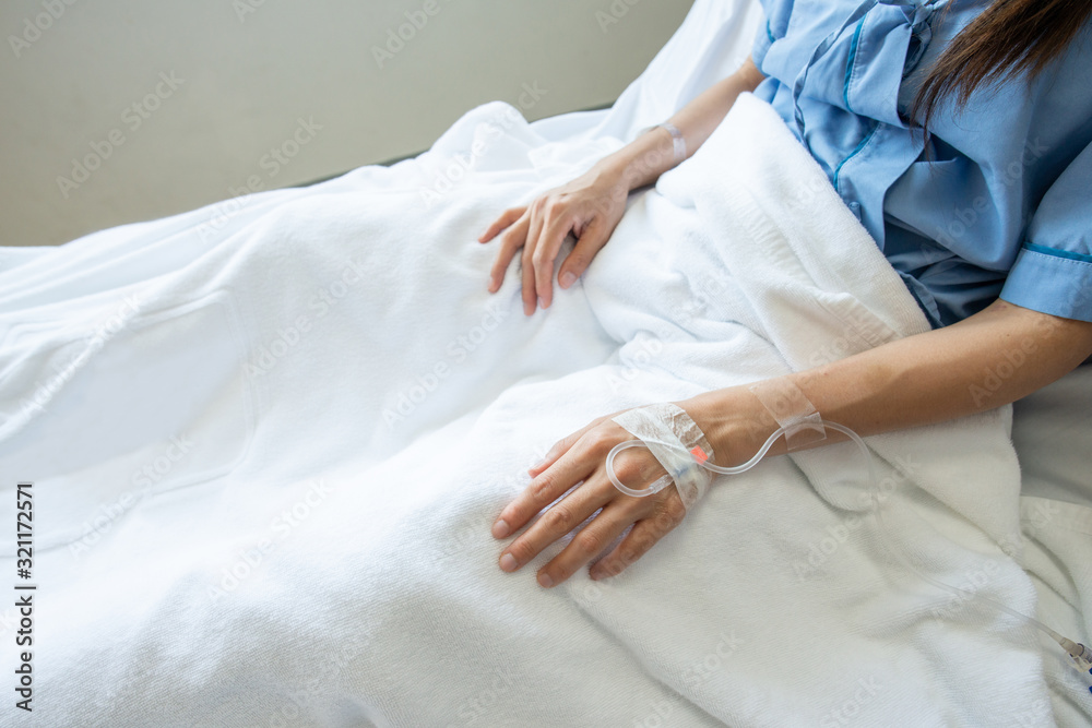 Patient woman sleeping with receiving intravenous fluid directly into a ...