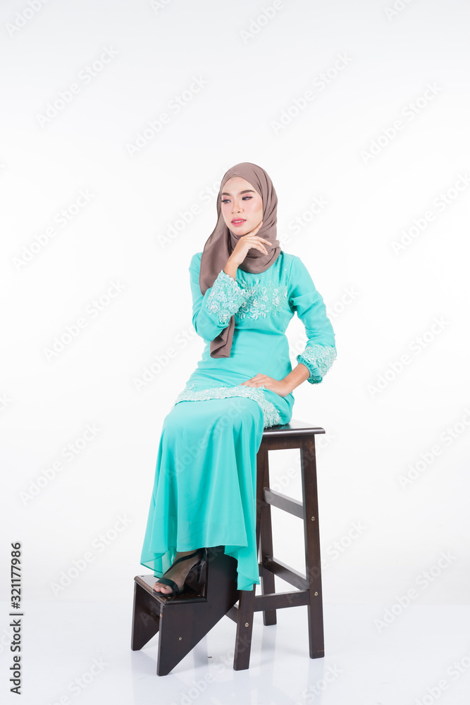 Beautiful female Muslim model in various poses wearing modern kurung ...