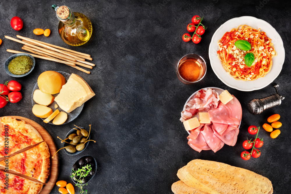 Italian food background with copy space. Pizza, pasta, cheese, hams ...