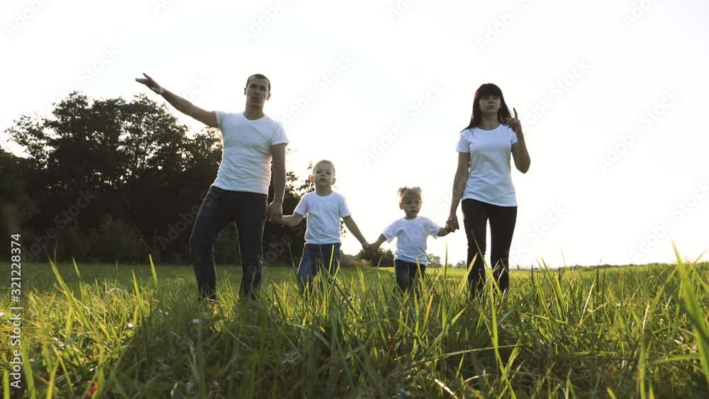 happy family teamwork daddy mother, little brother and sister walk in ...