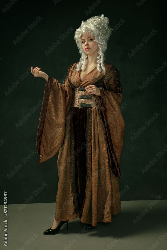 Elegance posing. Portrait of medieval young woman in brown vintage ...