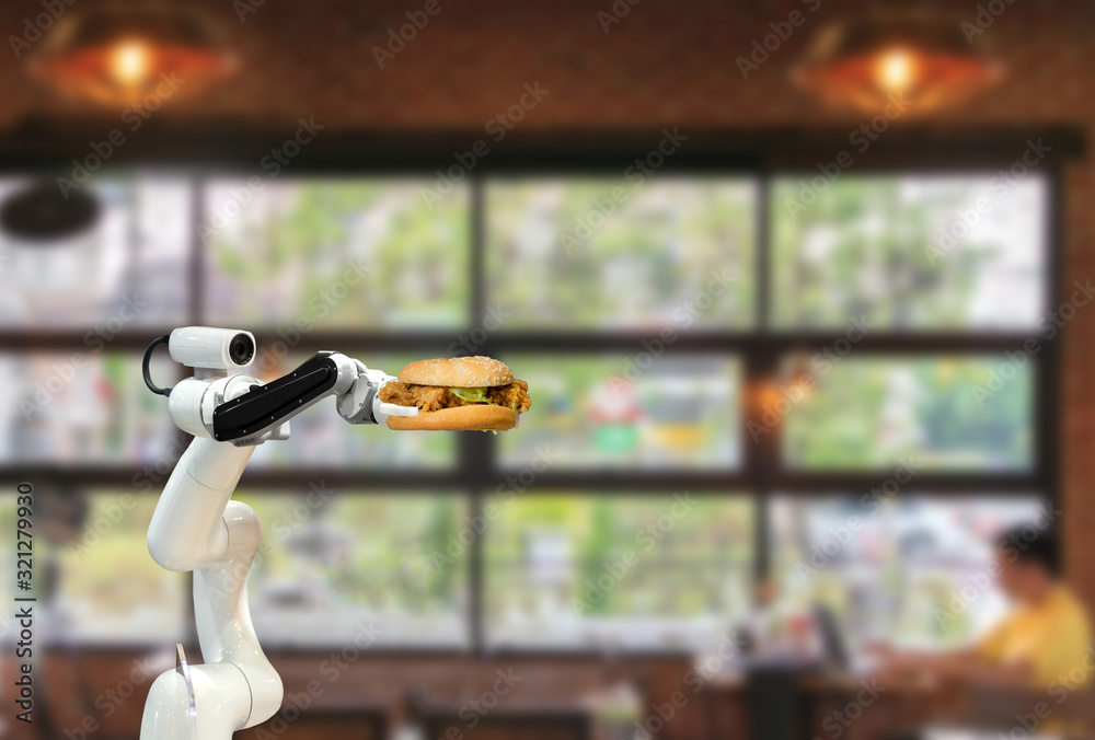 Smart robotic food holding a hamburger in a restaurant futuristic robot ...