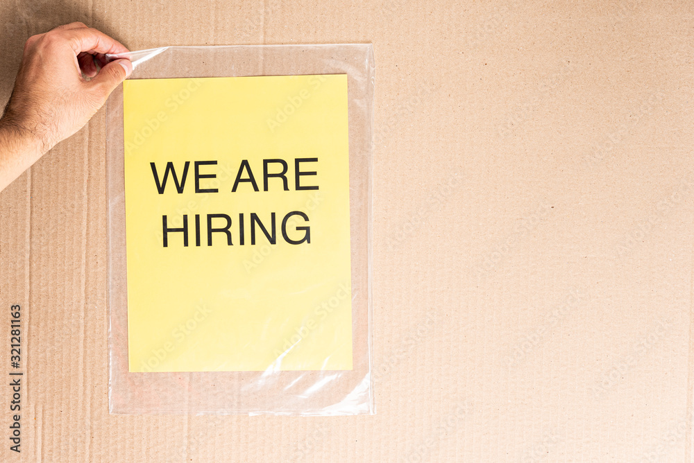 We are hiring text on yellow paper sheet on transparent bag and ...