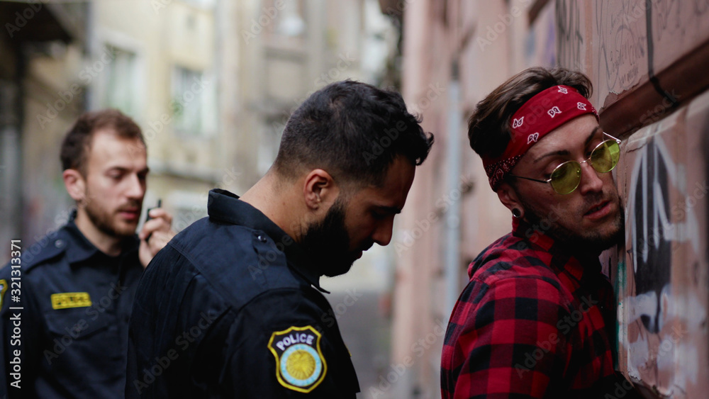 Police arrest. View of young man drug dealer near the wall being ...