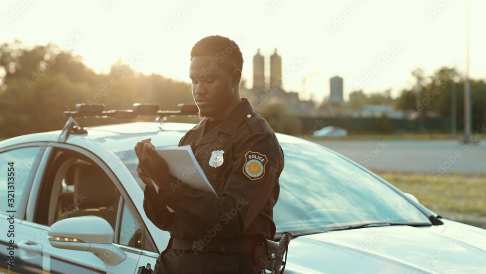 Portrait of attractive concentrated young black man police officer ...