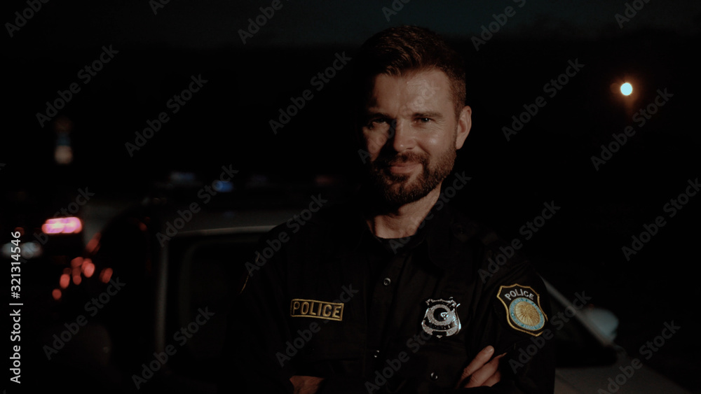 Portrait of confident professional cop smiling with arms crossed ...