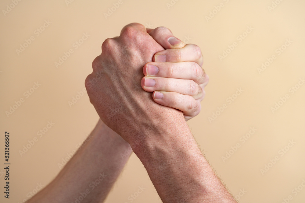 Two hands. Arms wrestling. Friendly handshake, friends greeting ...