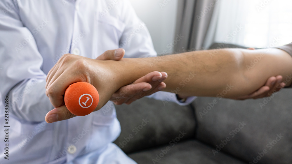 instructor assisting senior doing exercise working out in clinic ...