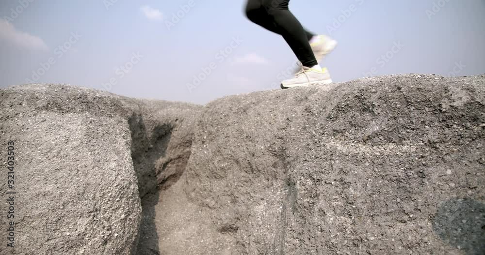 SLOW MOTION, Close up Trail running in the rock mountain rubble high ...