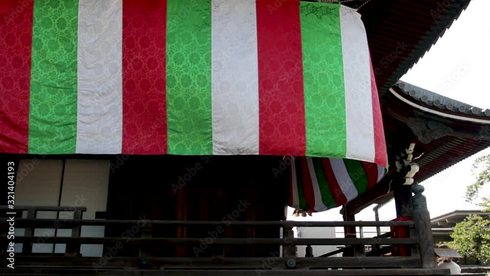 Shinran Shonin Japanese Temple Architecture . Green, White, Red flag ...