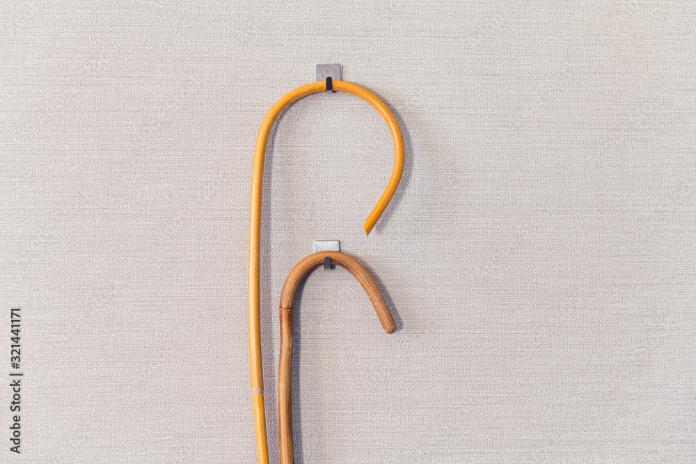 School rattan canes on hooks on the wall. Dragon rattan cane prepared ...