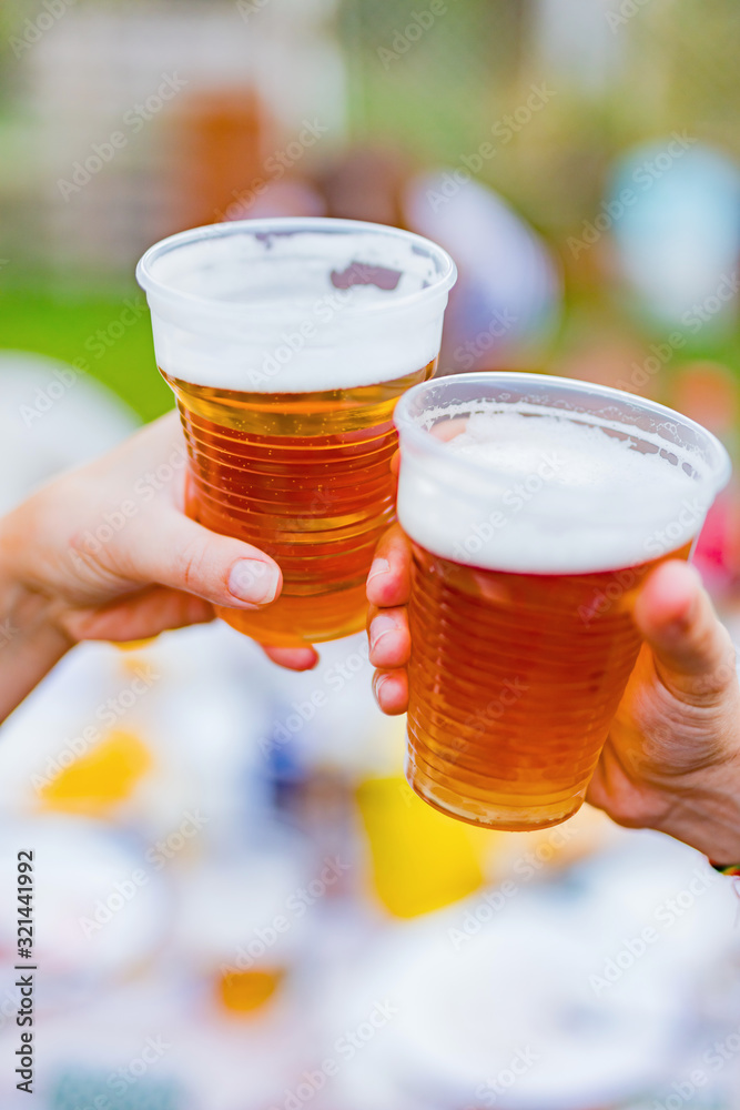 Friends enjoying drinking beer in the backyard. Stock Photo | Adobe Stock