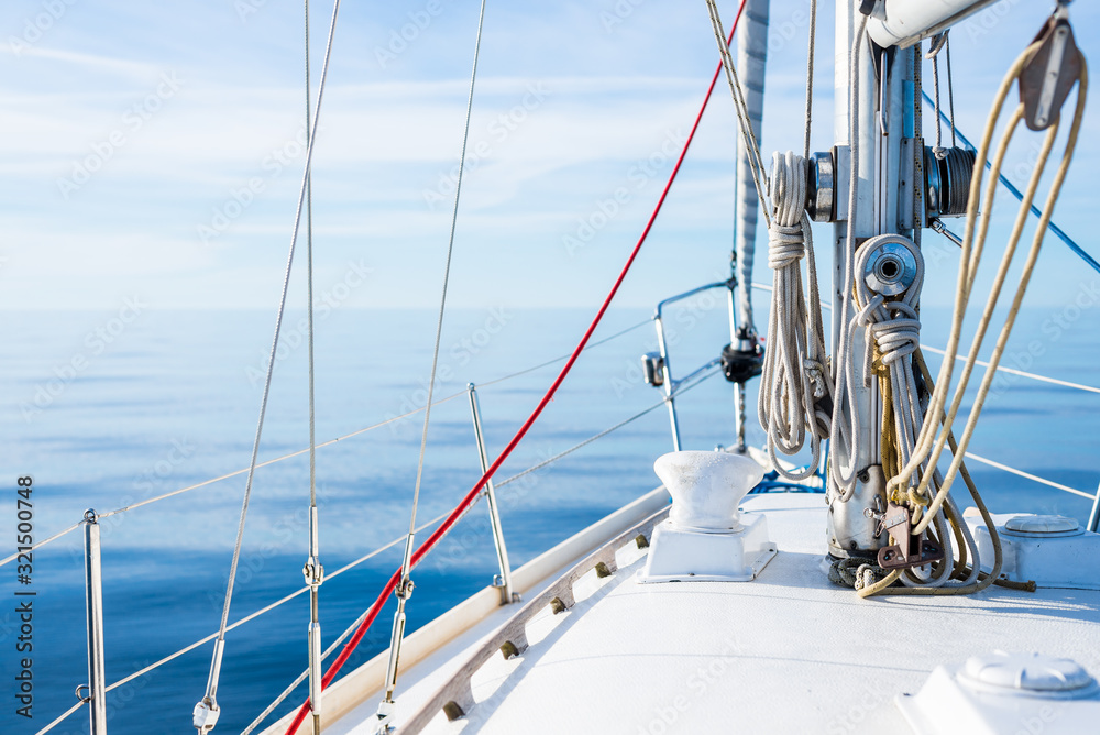 White sloop rigged yacht sailing in a still water of the Baltic sea on ...