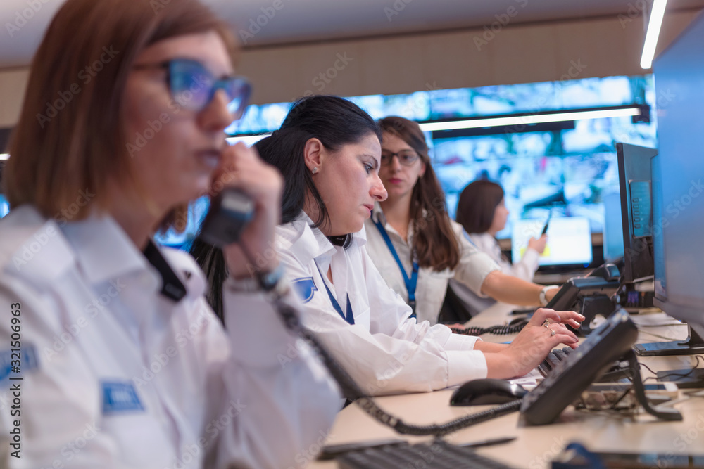 Security guard monitoring modern CCTV cameras in a surveillance room ...