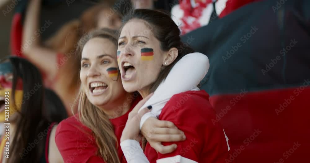 German spectators in stadium cheering together. People from Germany in ...