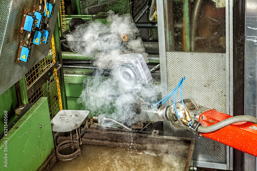 A piece coming out of a die casting machine has just been cooled down ...