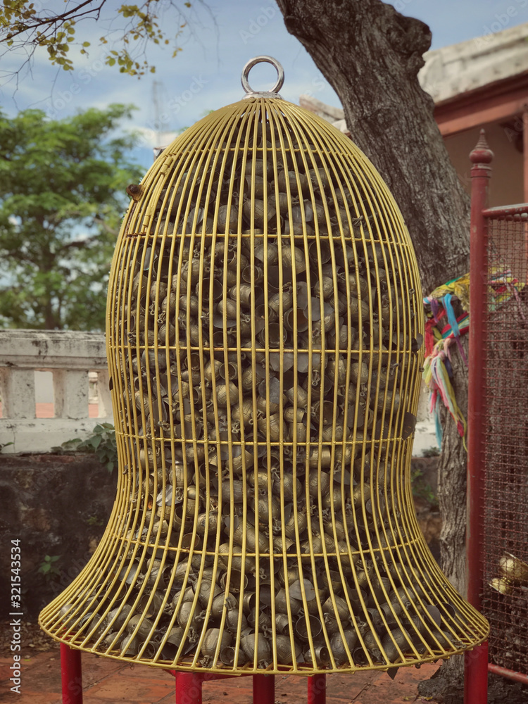 Bells stacked inside a bell shaped copper basket in Thailand. Stock ...