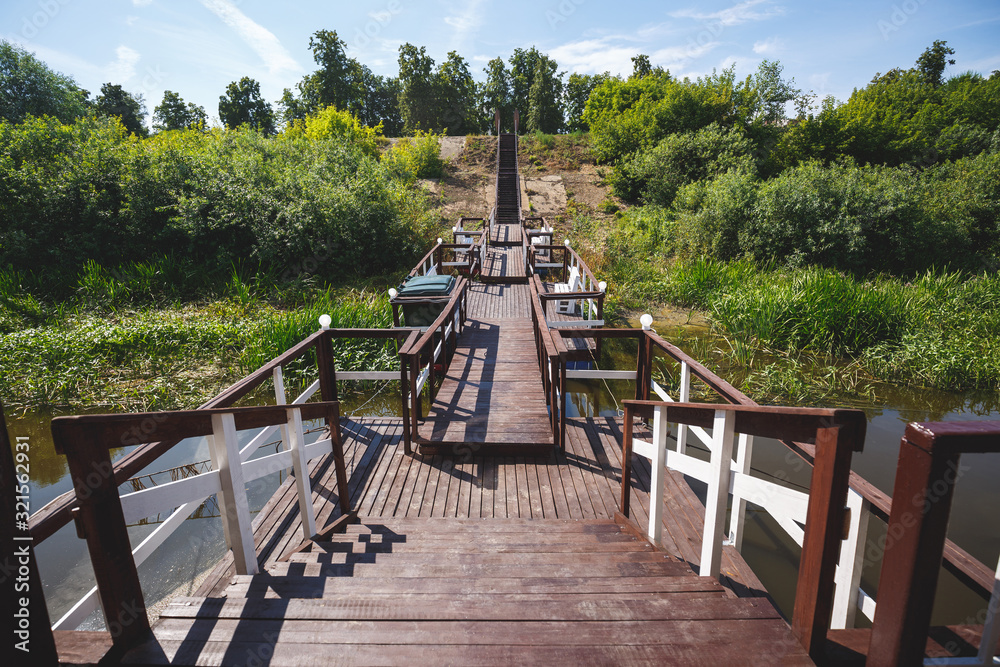 Beautiful wooden descent from the landing stage to land. Staircase and ...