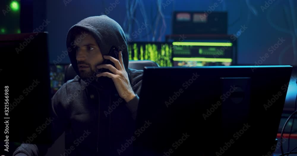 Caucasian young man software developer and programmer in a hood working ...