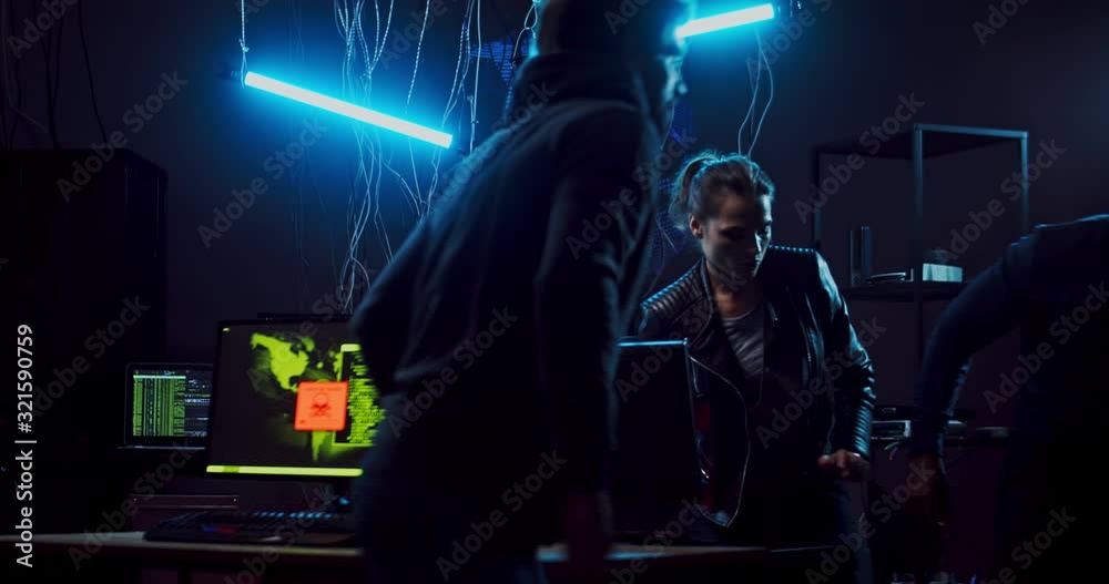 Three multiethnic young male and female hackers leaving the place of ... Three multiethnic young male and female hackers leaving the place of ...